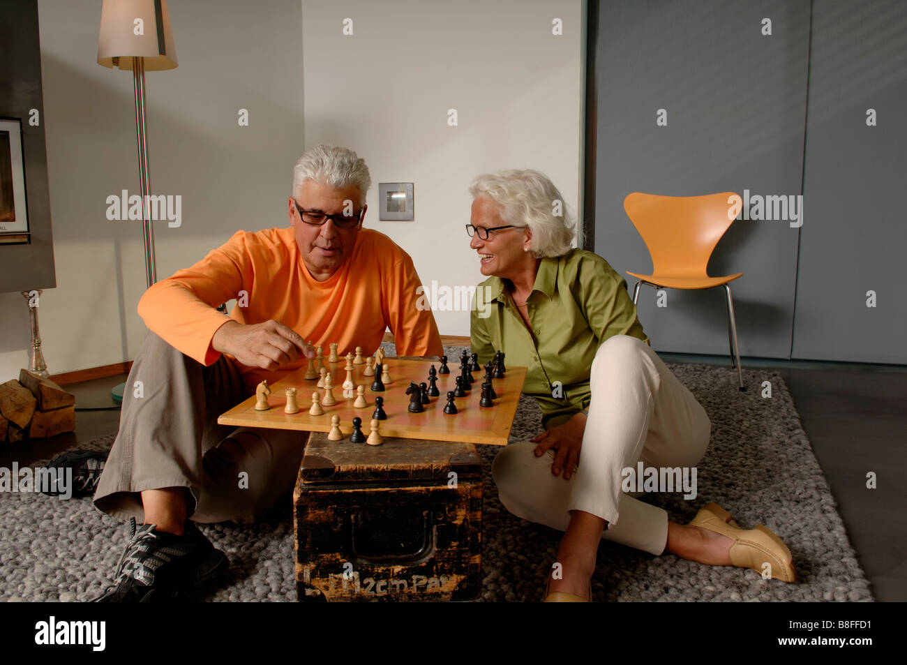 Woman playing chess indoors grey hi-res stock photography and images ...
