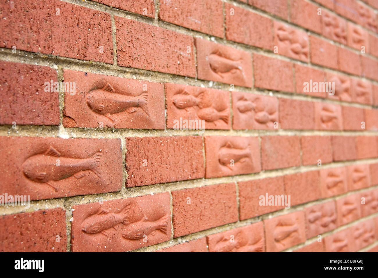 Brick wall with an inlaid fish motif, Bridlington, England Stock Photo ...
