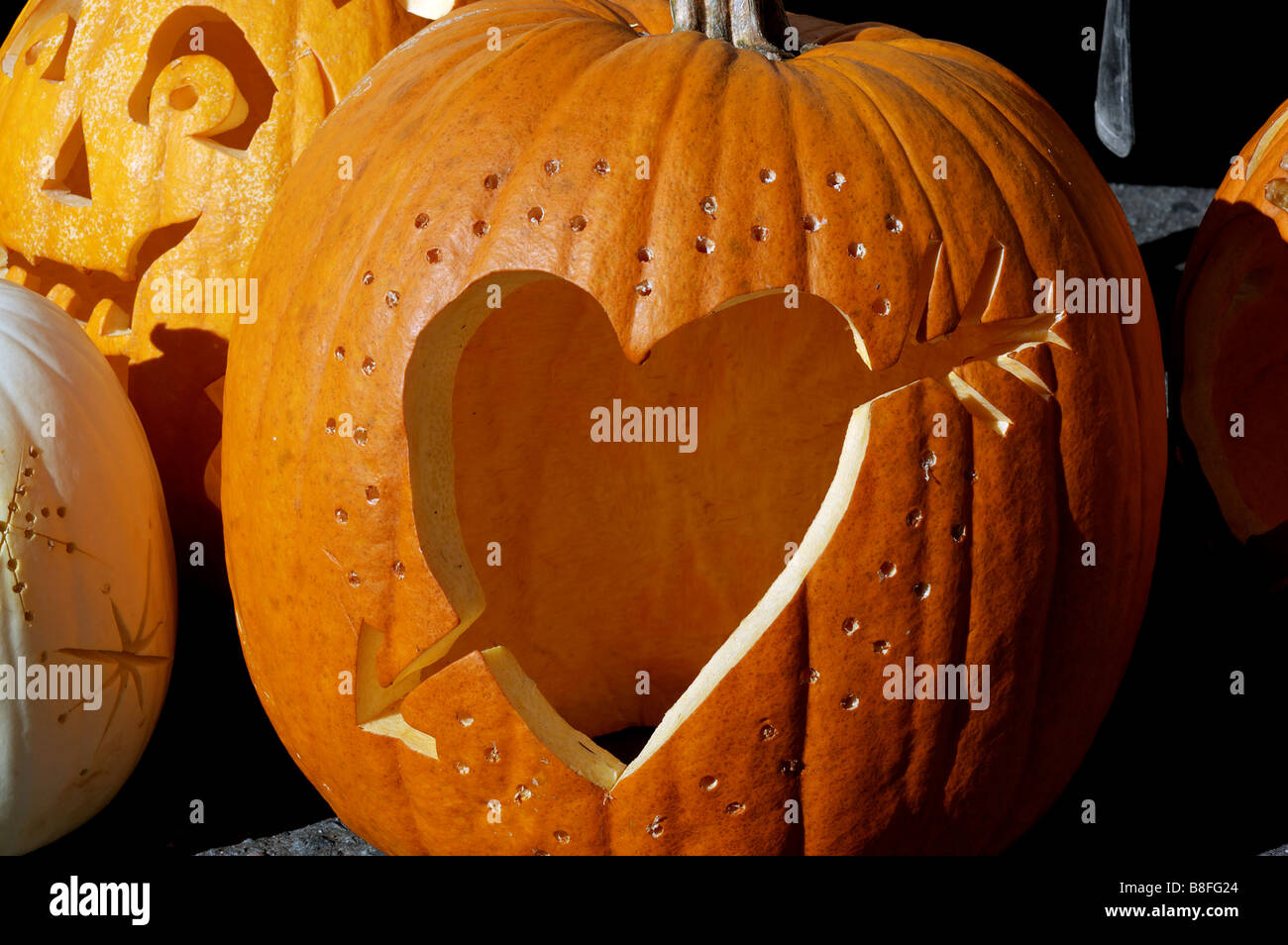 A pumpkin with a love heart and arrow carved in it Stock Photo - Alamy