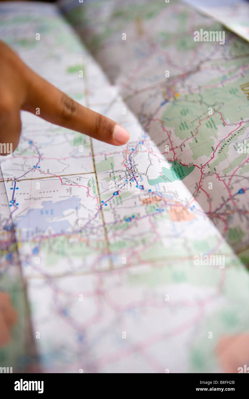 close up of a person's finger pointing at a map of southwestern united ...
