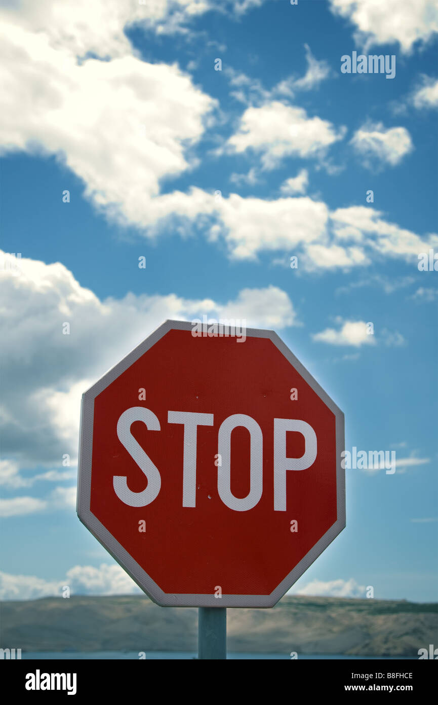 Stop sign by the road Stock Photo - Alamy