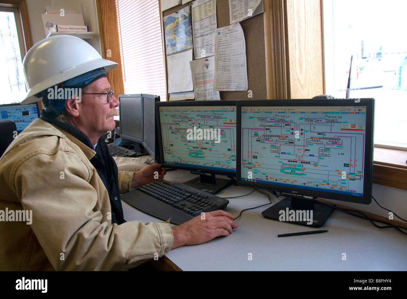 Operator checks computers monitoring the systems of a geothermal power ...