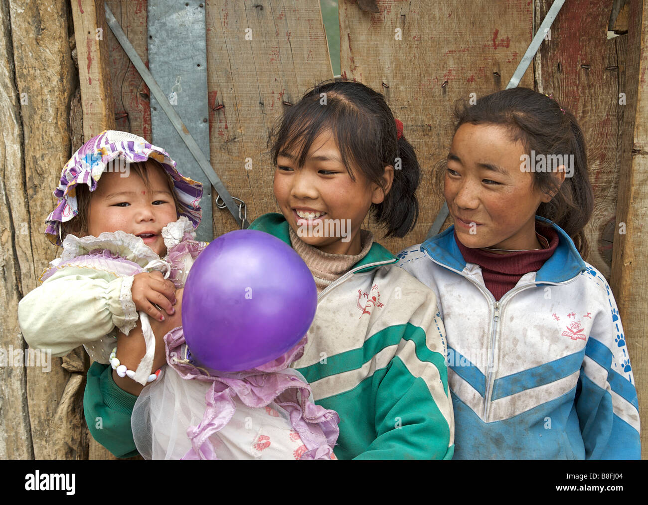 Tibetan girls and baby with balloon Stock Photo - Alamy