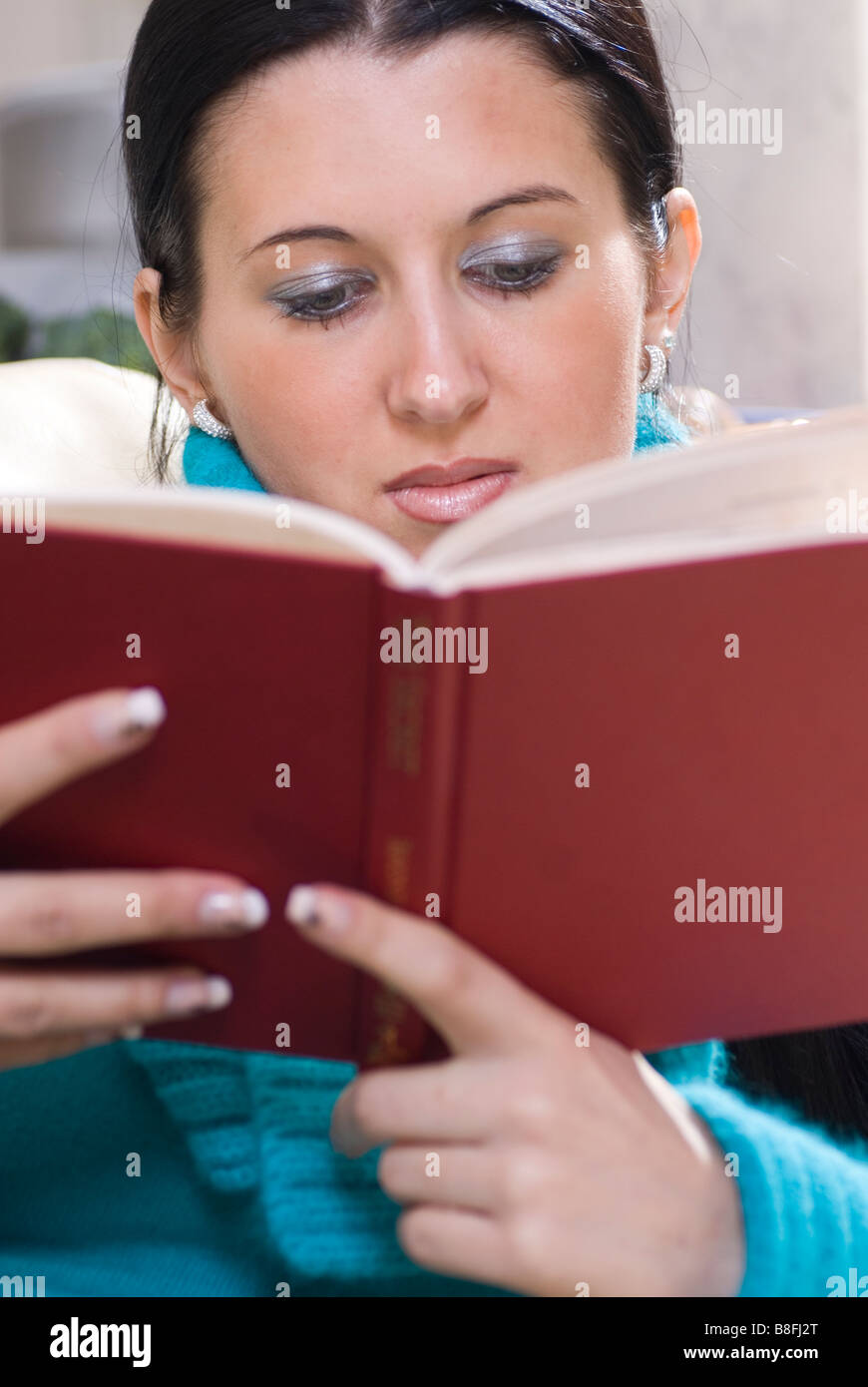 Beautiful young woman reading a book Stock Photo - Alamy
