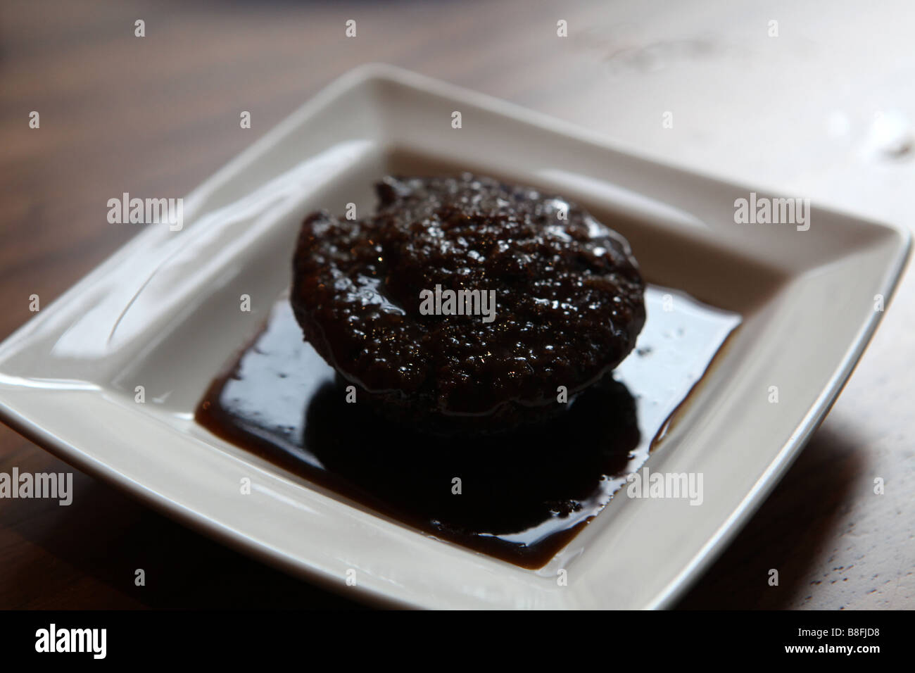 a selection of small appetizing cakes on some plates on a table in a ...