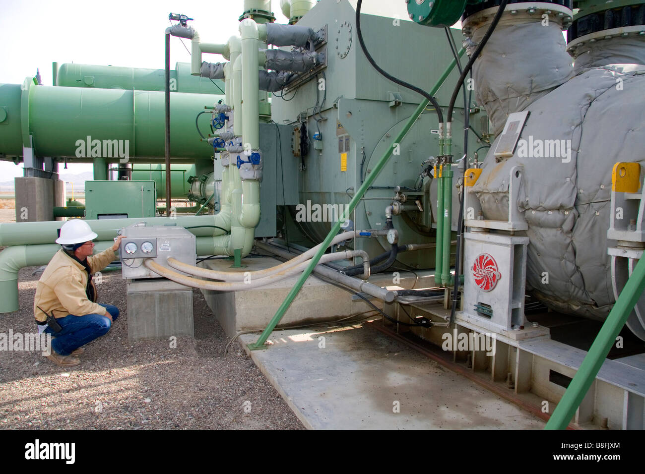 Operator checking the workings of a geothermal power plant in Malad ...