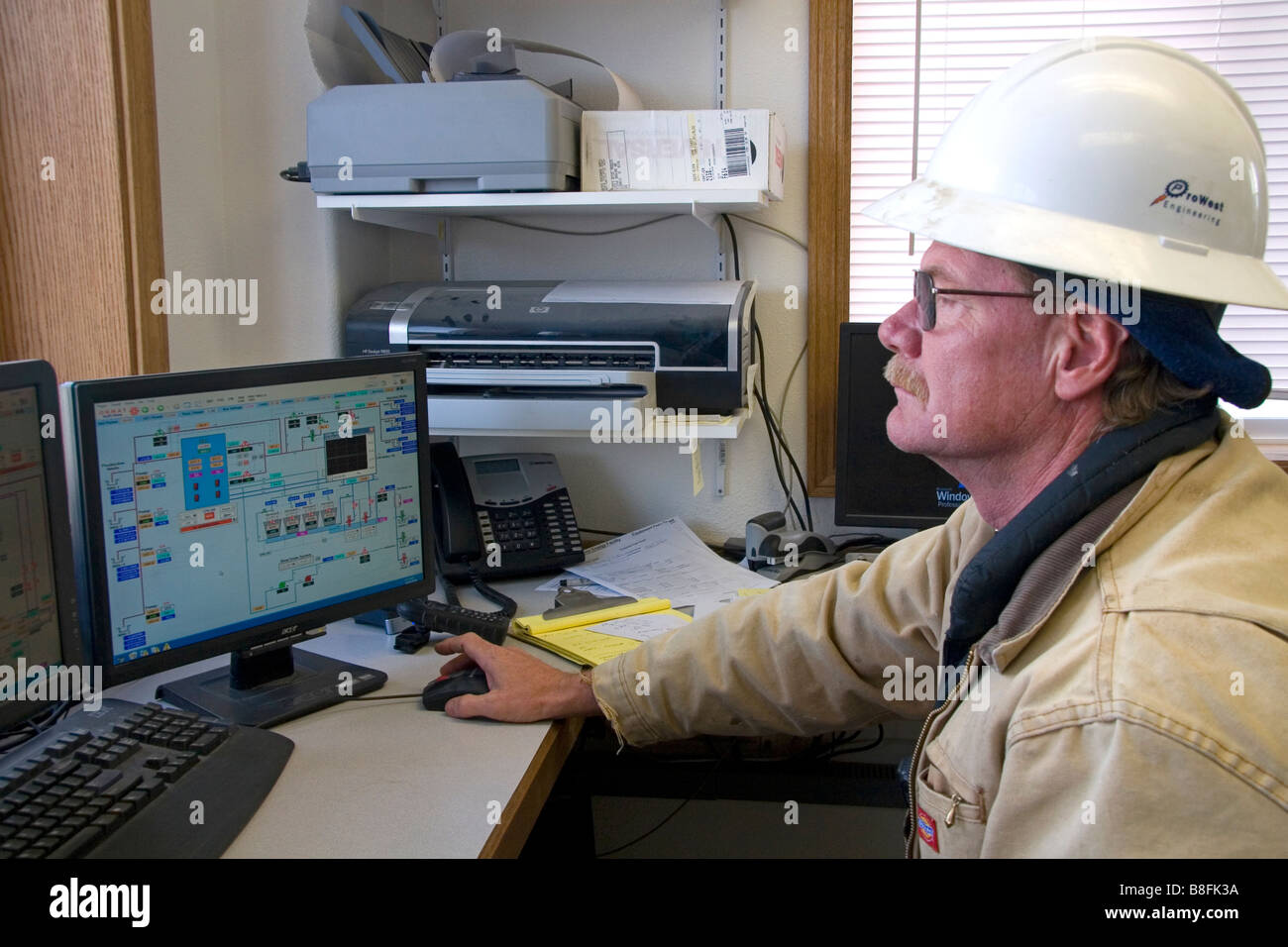 Operator using computers to monitar the system of a geothermal power ...