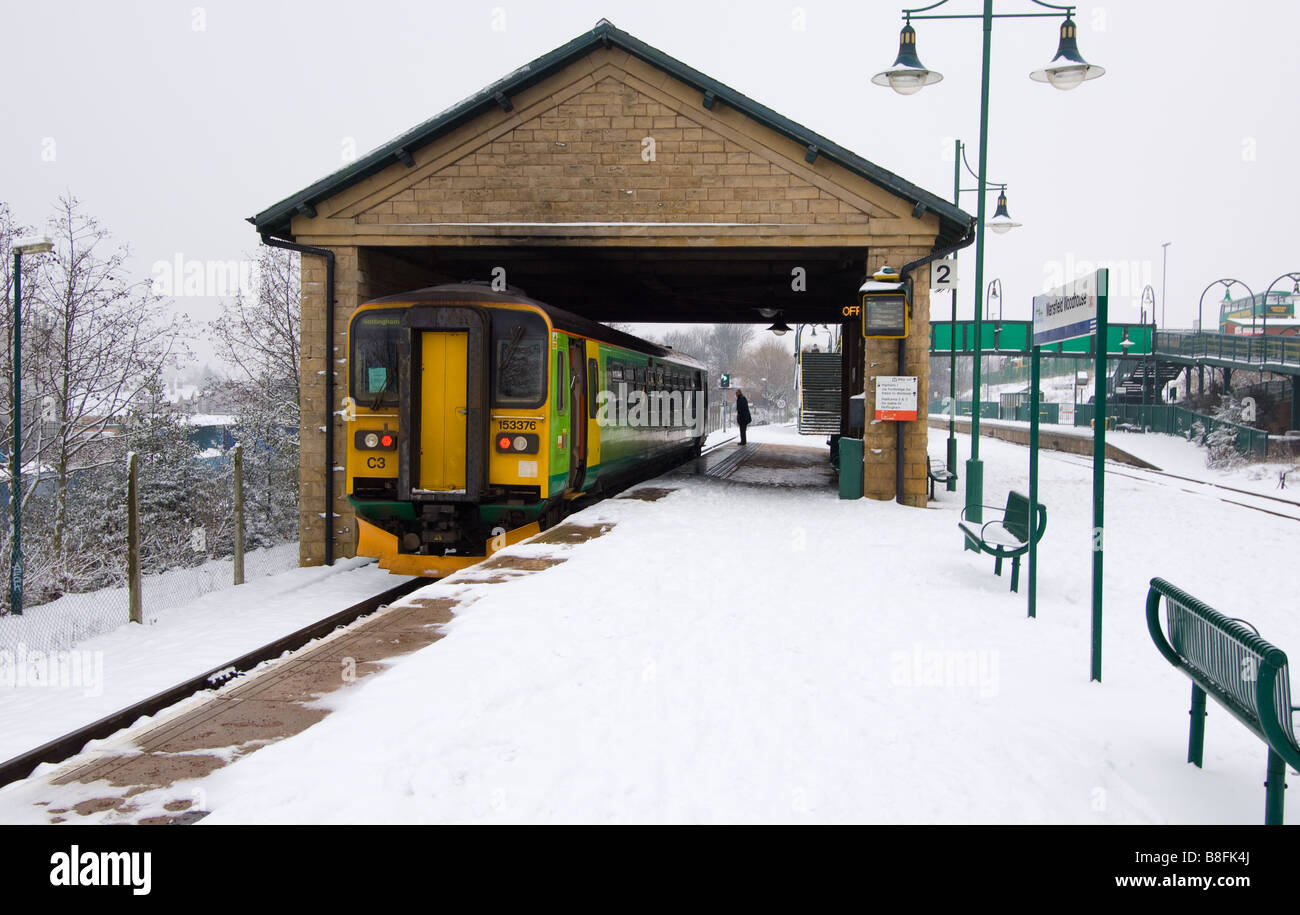 Commuter train pulling out of the local train station after a snow fall ...