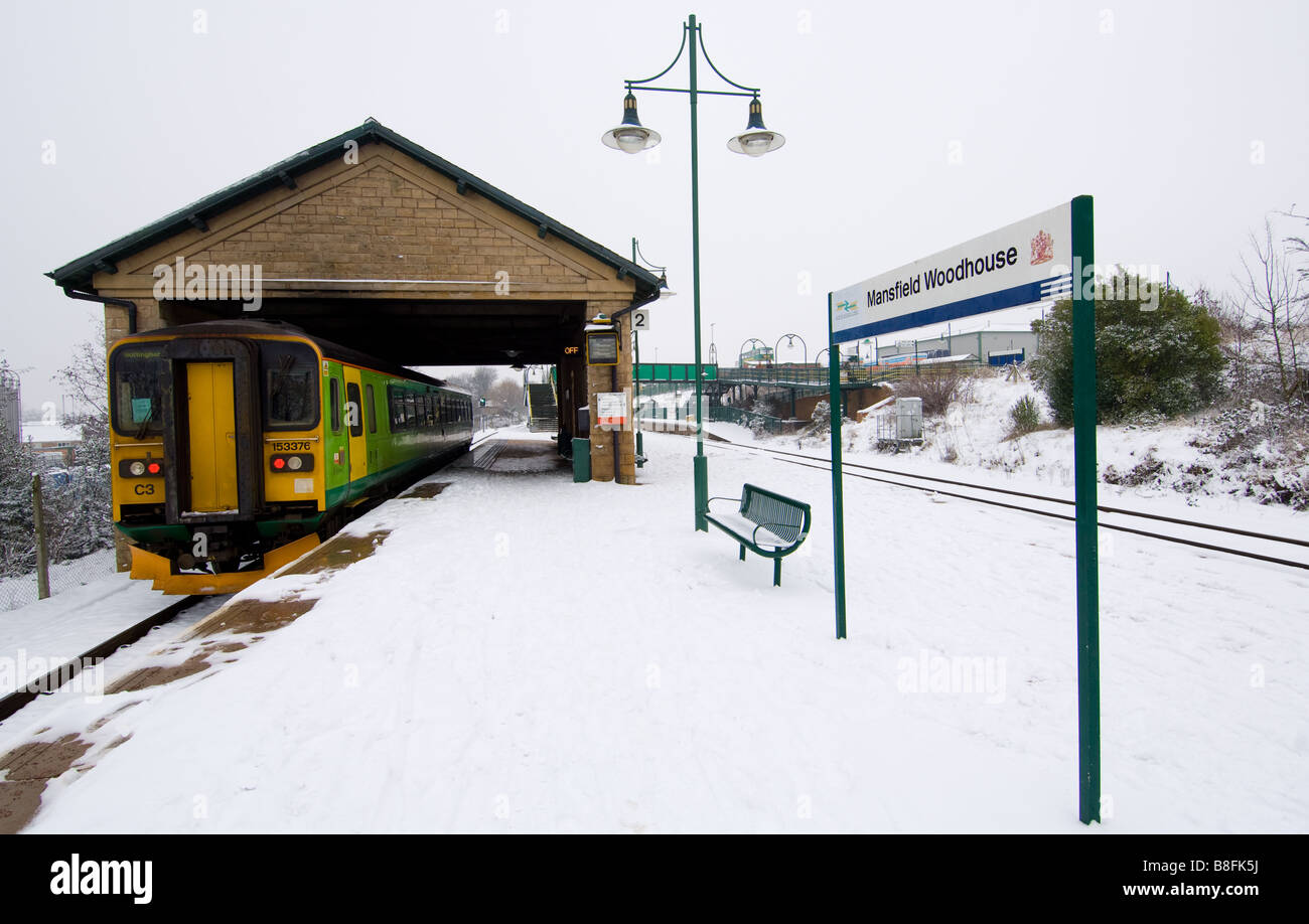 Commuter train pulling out of the local train station after a snow fall ...