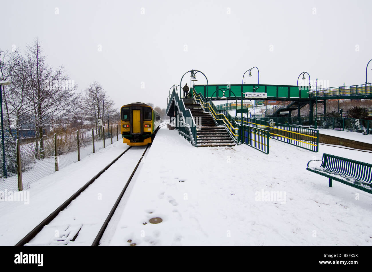 Commuter train pulling out of the local train station after a snow fall ...