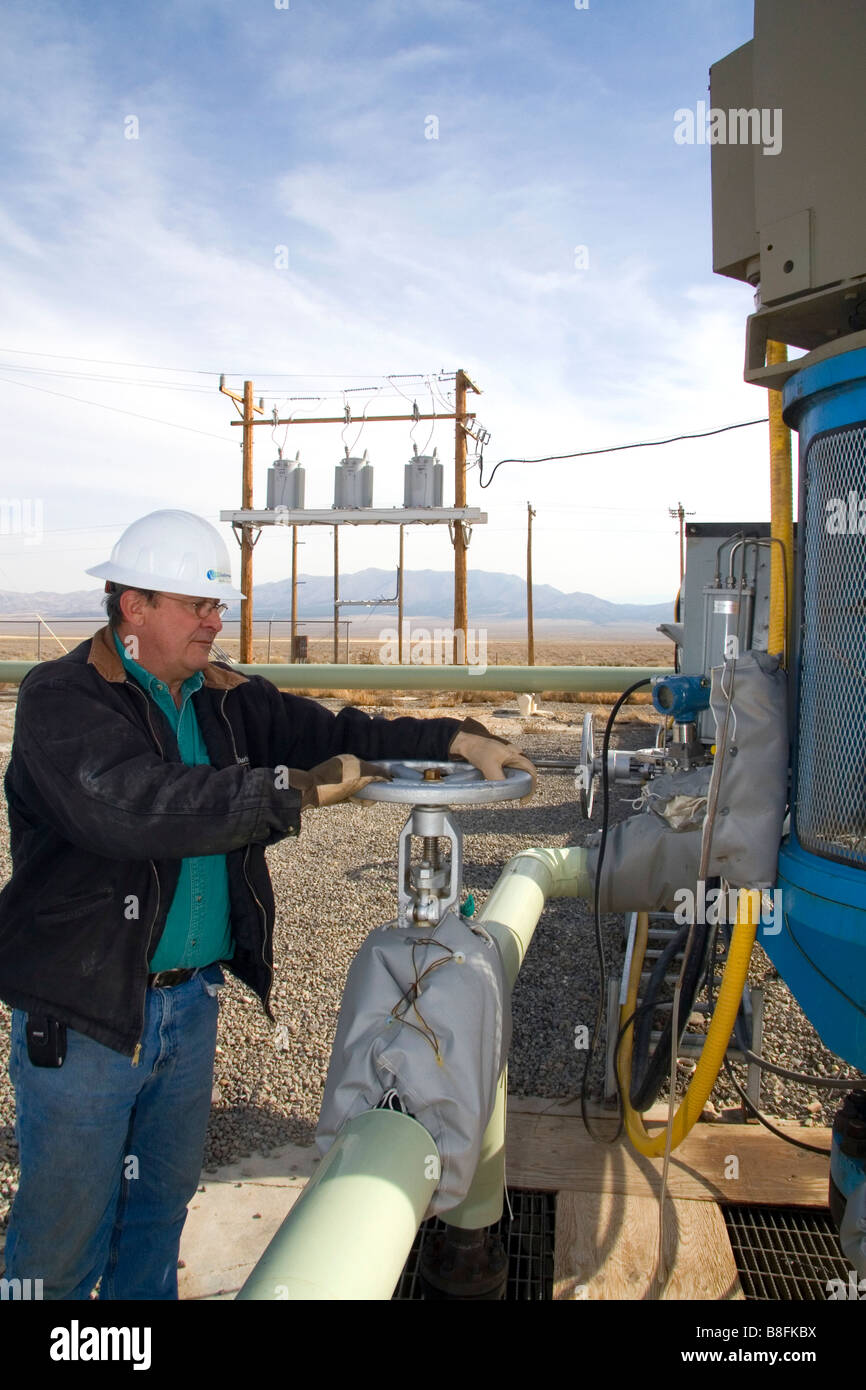 Operator turning a valve at a geothermal electric power plant in Malta ...