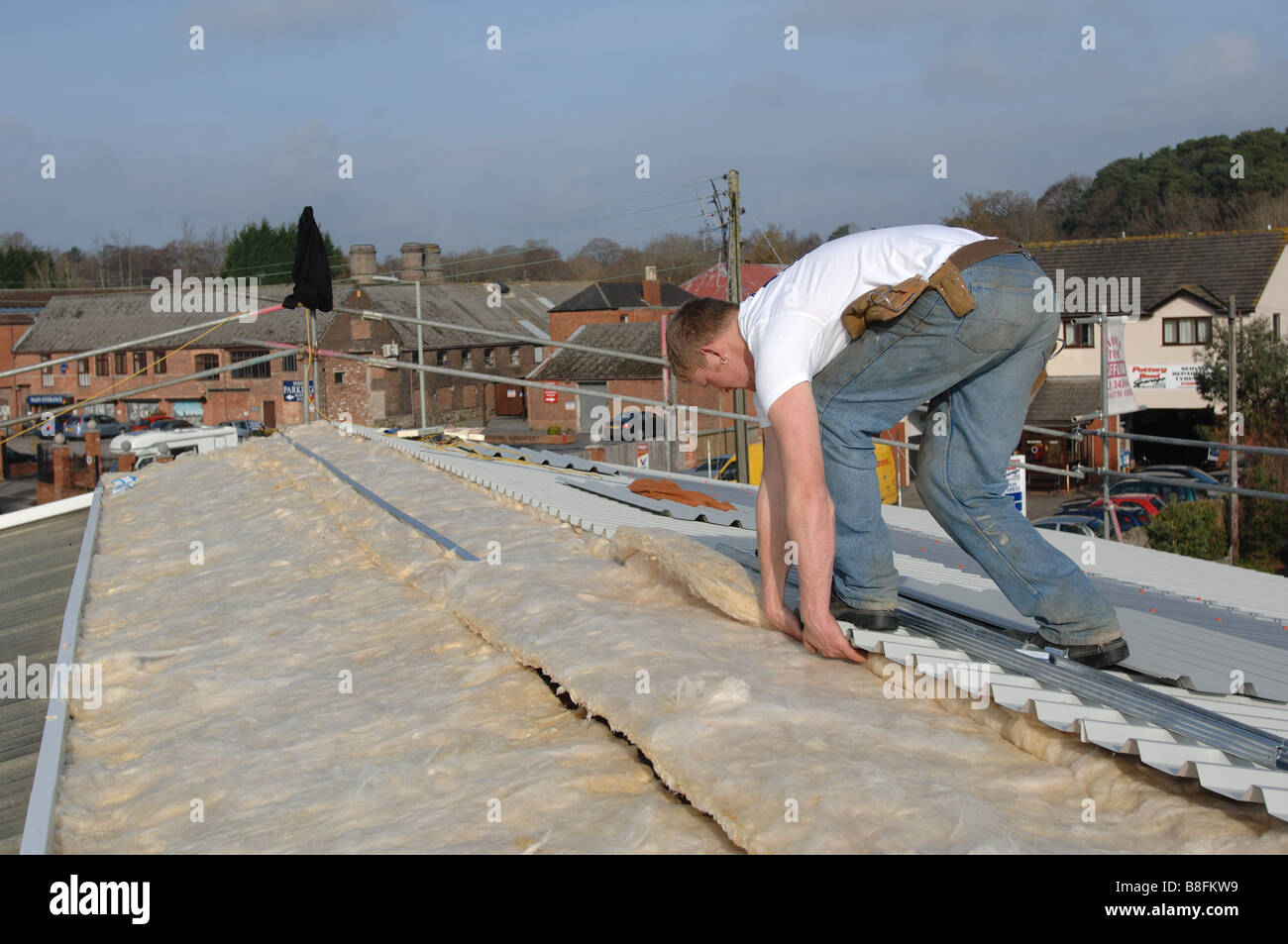 Contractors lay extra Insulation on roof of an industrial unit in Bovey ...