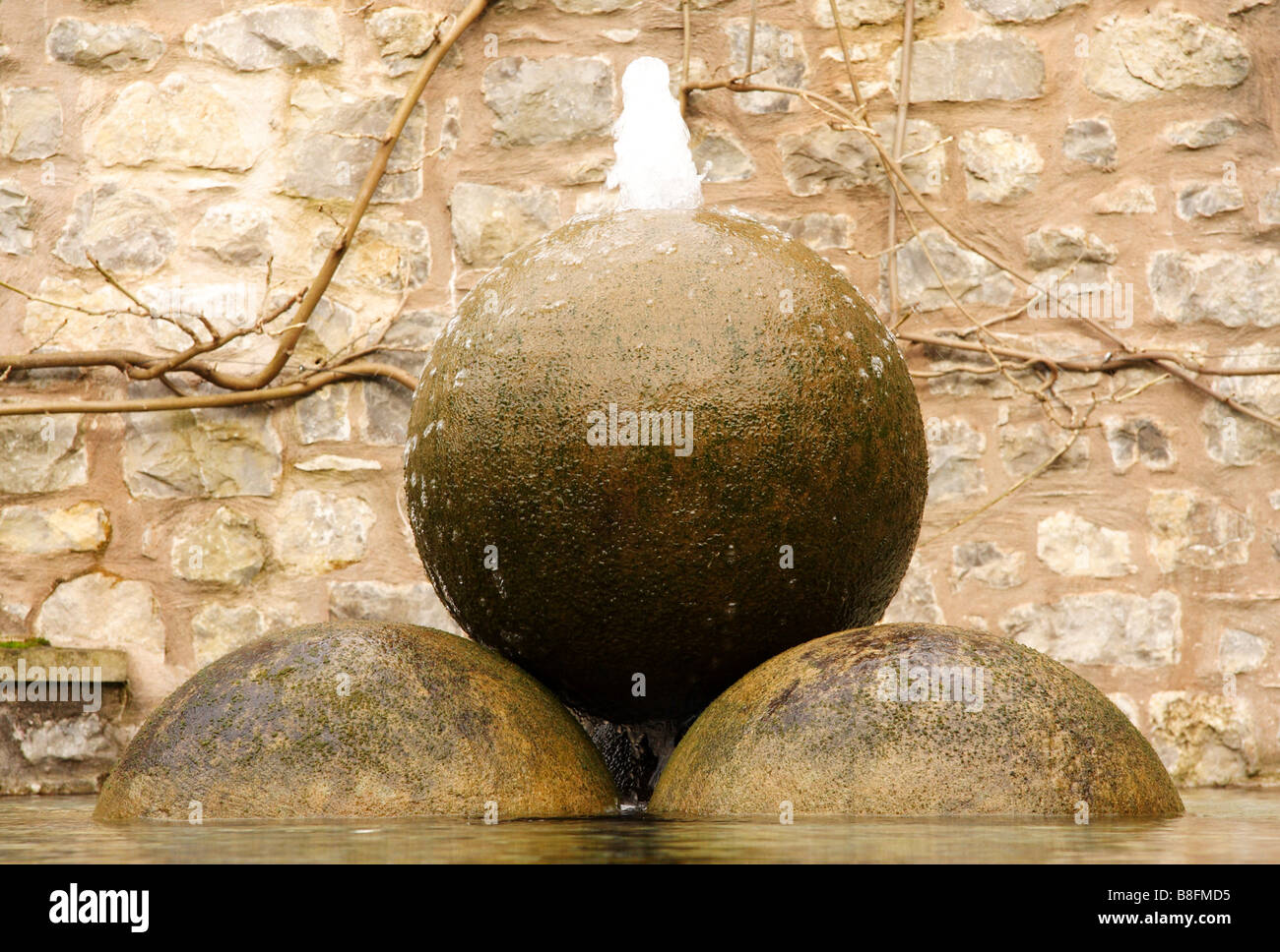 A water fountain made of three concrete balls Stock Photo - Alamy