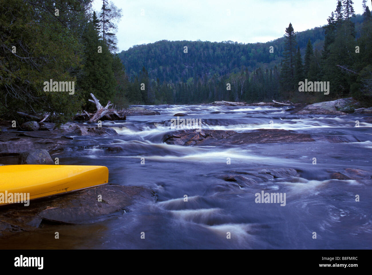 Overturned canoe at rapids of river Stock Photo - Alamy