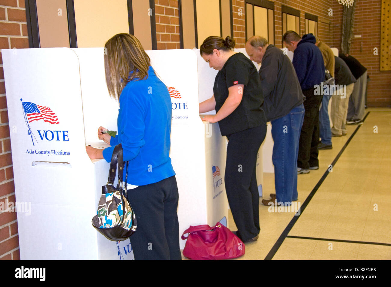 Voters using cardboard voting booths at a polling station in Boise ...
