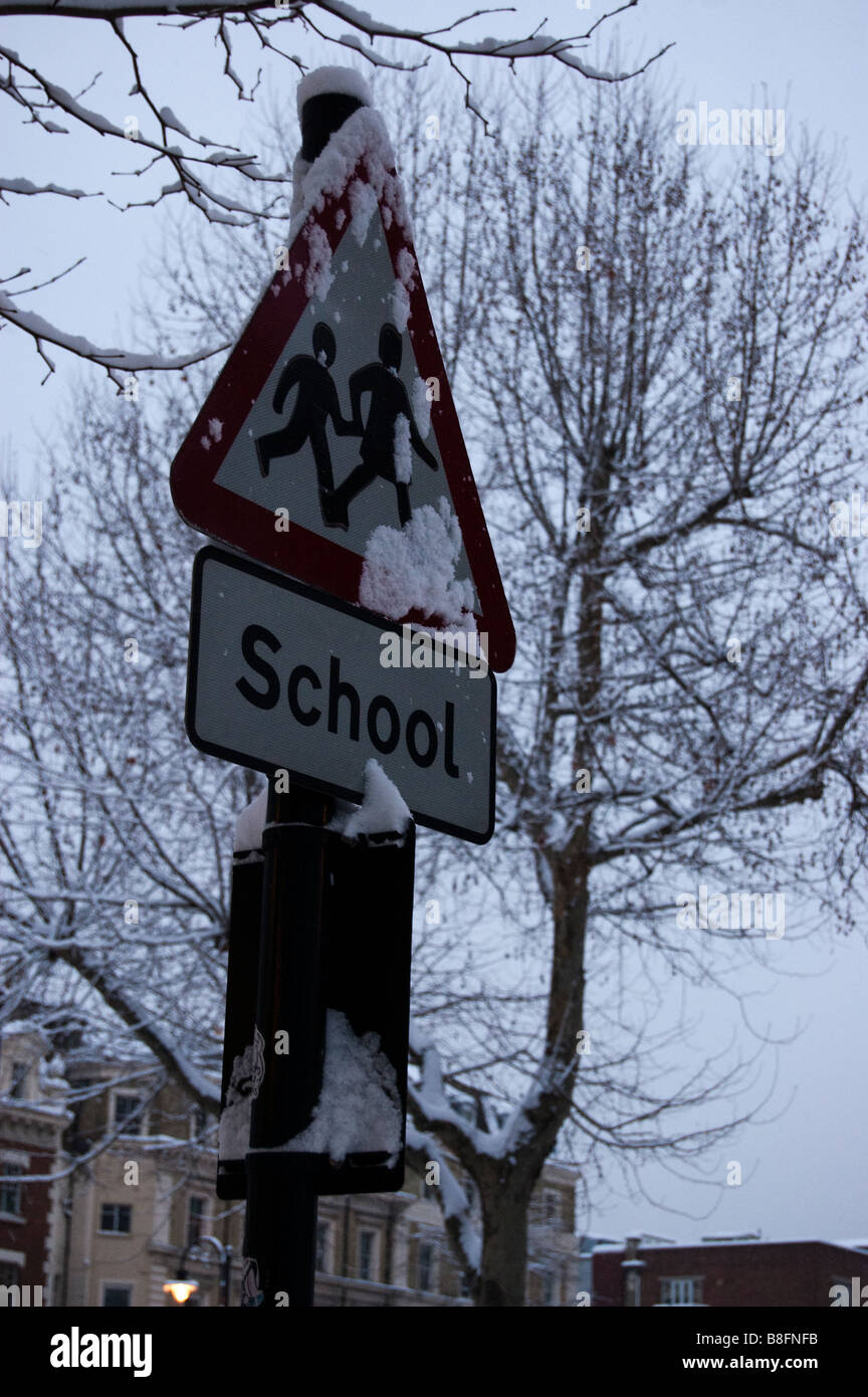 School crossing sign with snow Stock Photo - Alamy
