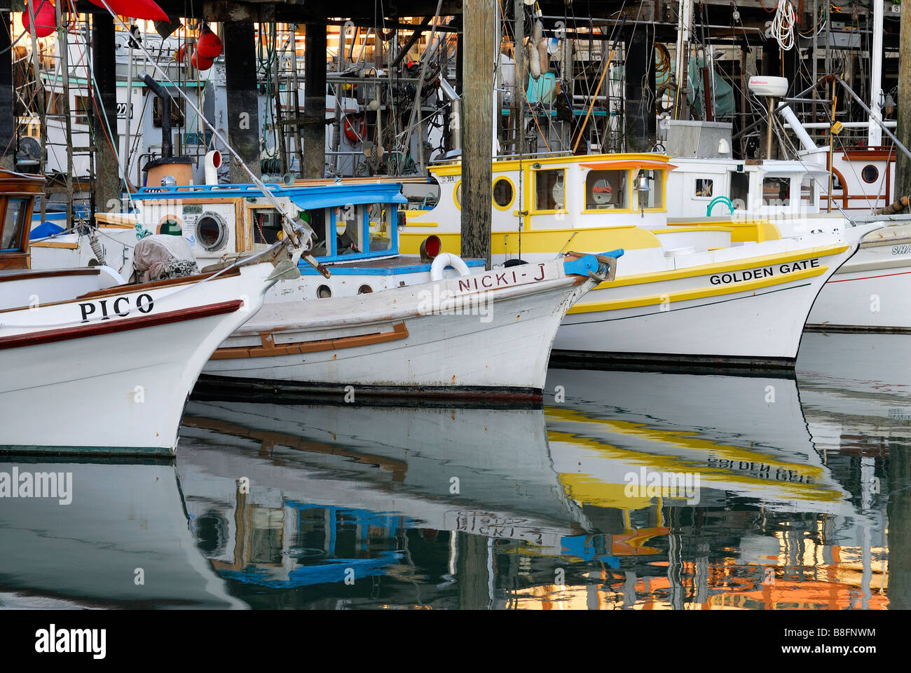 traditionnal wood fishing boat in San Franciso harbour hull reflects ...