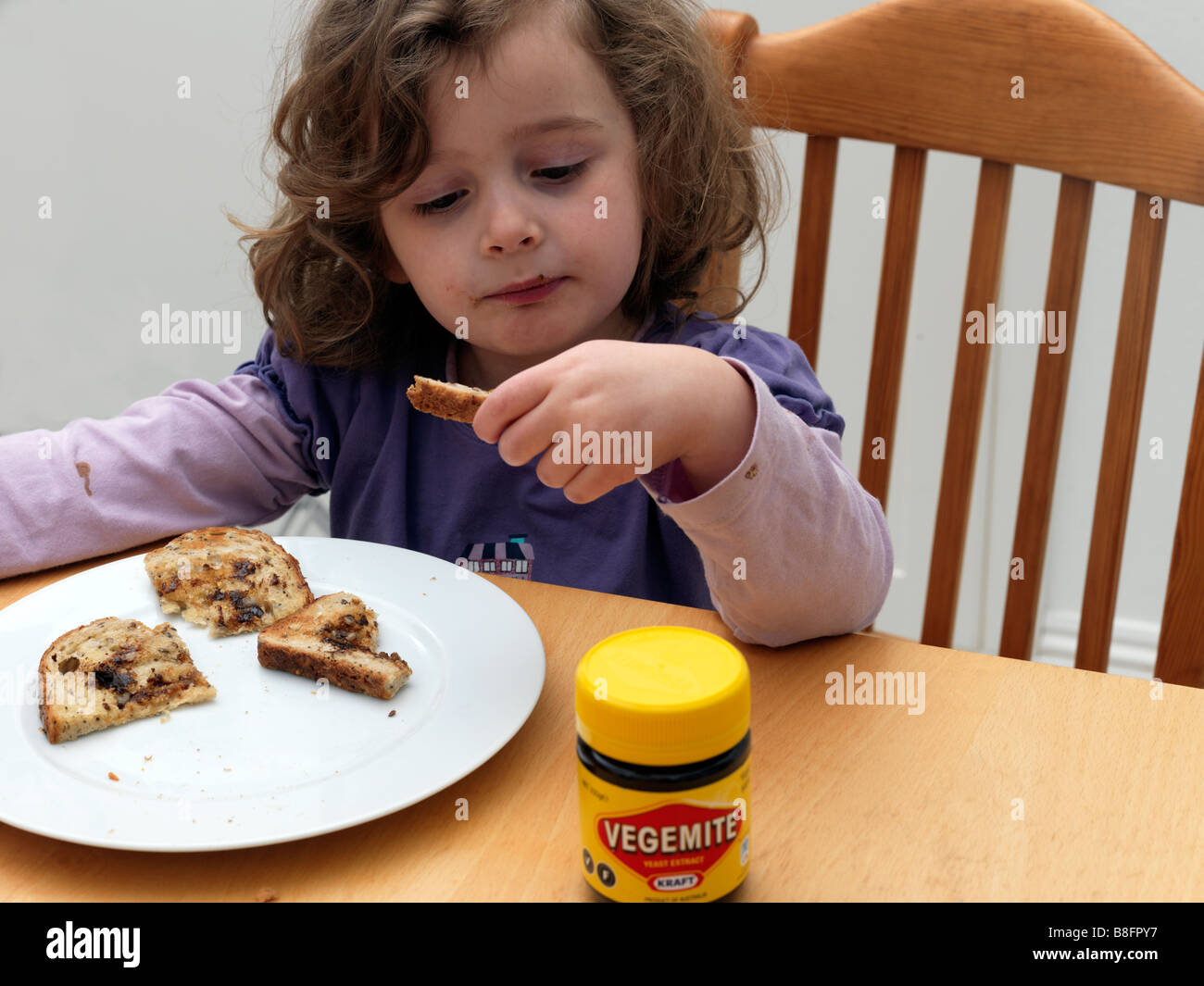 Four Year Old Child Eating Vegemite Stock Photo - Alamy