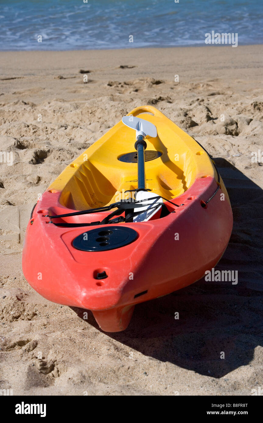 A boat with red and yellow color on the beach Stock Photo - Alamy