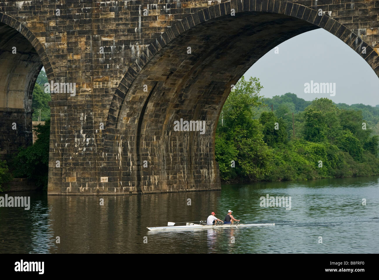 Rowers pass under Penn Central bridge on the Schuylkill River ...
