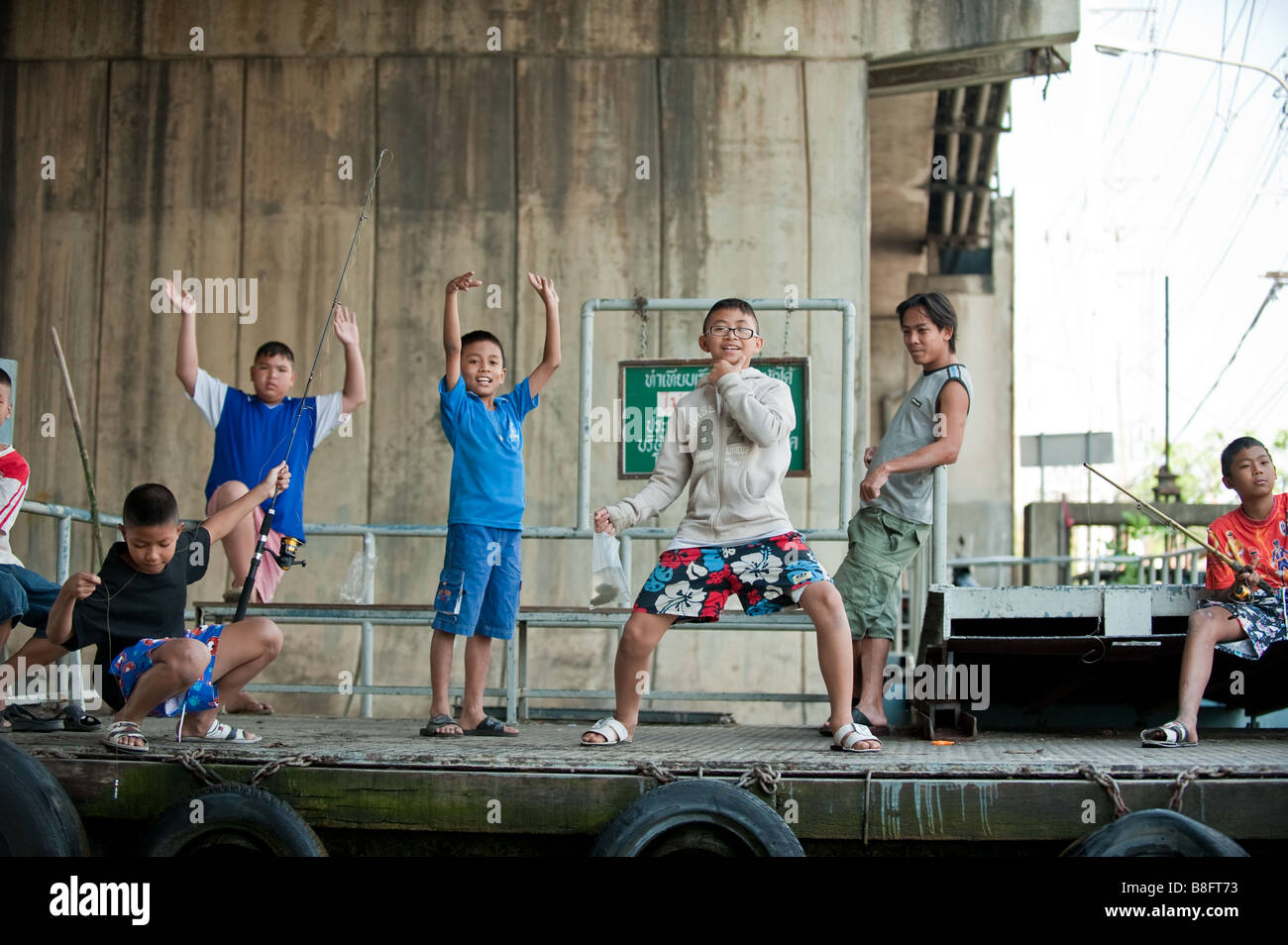 Kids playing under a bridge in Bangkok Stock Photo - Alamy