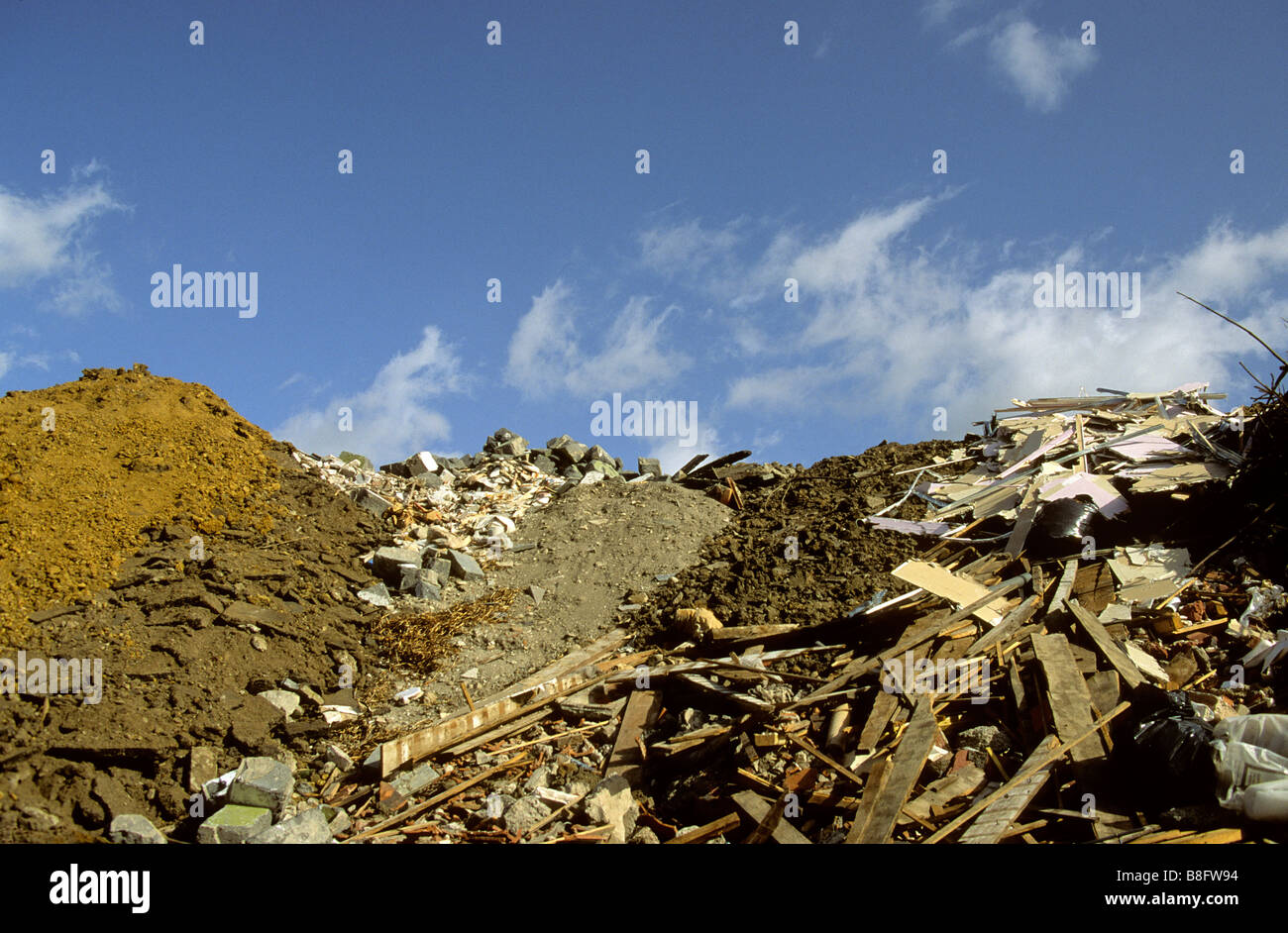 Piles of construction debris under a clear blue sky in a demolition ...