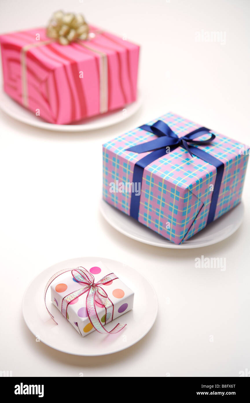 Close up of three wrapped presents on the plate Stock Photo - Alamy
