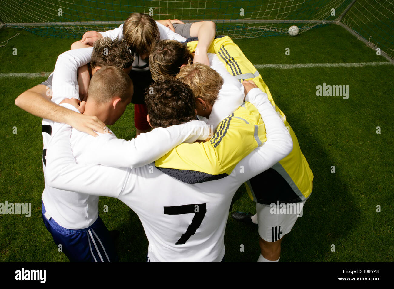 Footballers of one team and their goalkeeper hugging each other before ...