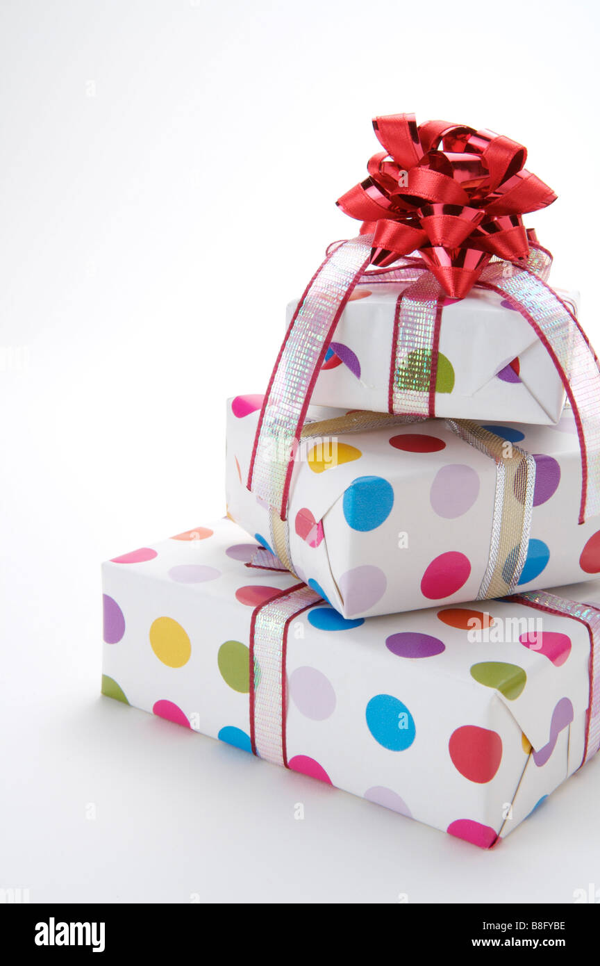 Three wrapping gifts with ribbon Stock Photo - Alamy