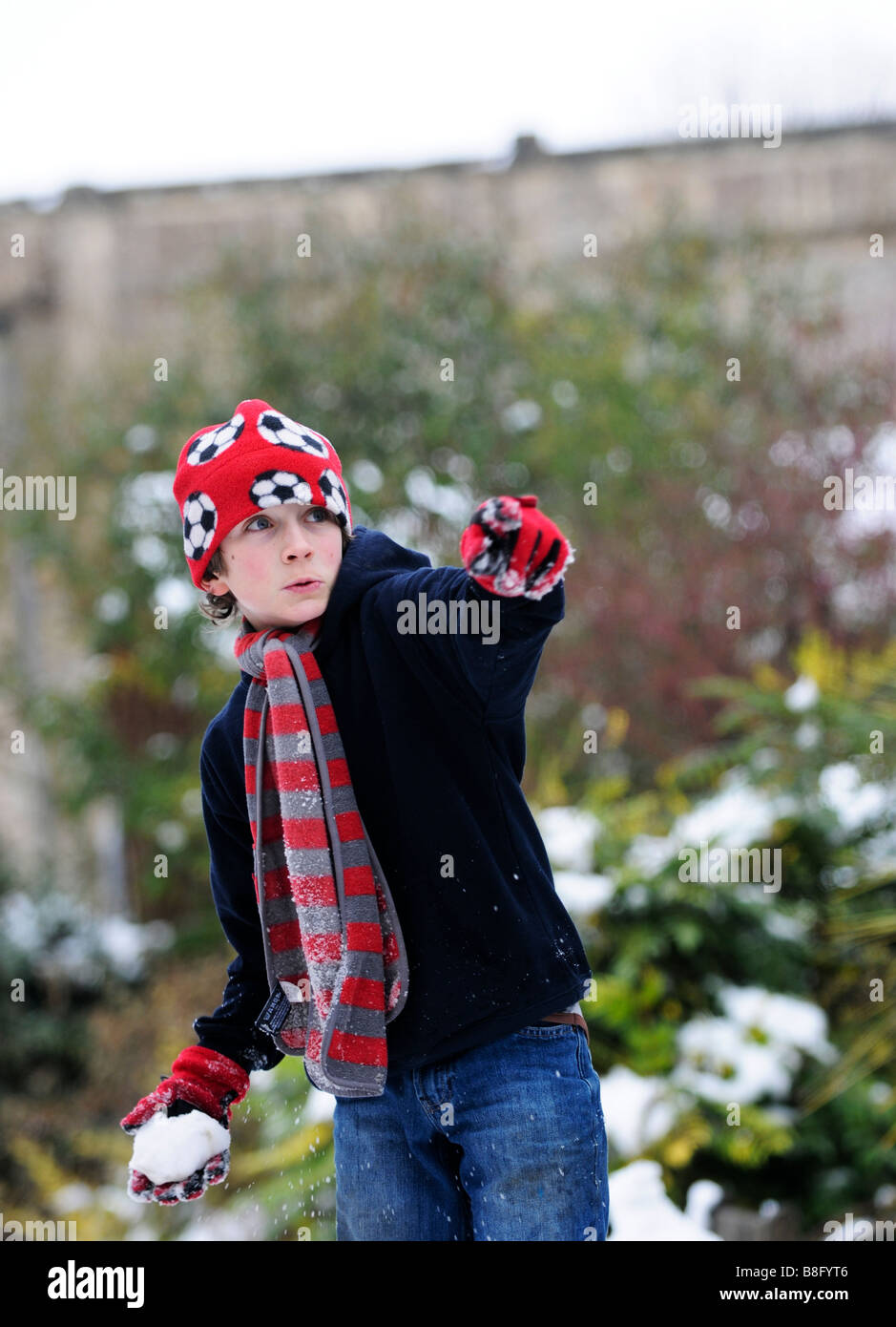 action shot of boy throwing snowball Stock Photo - Alamy