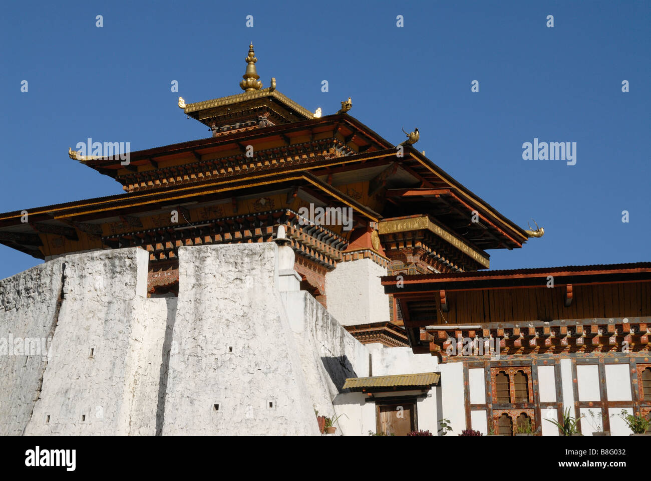 The vast whitewashed stone walls and ornate roof of Punakha Dzong ...