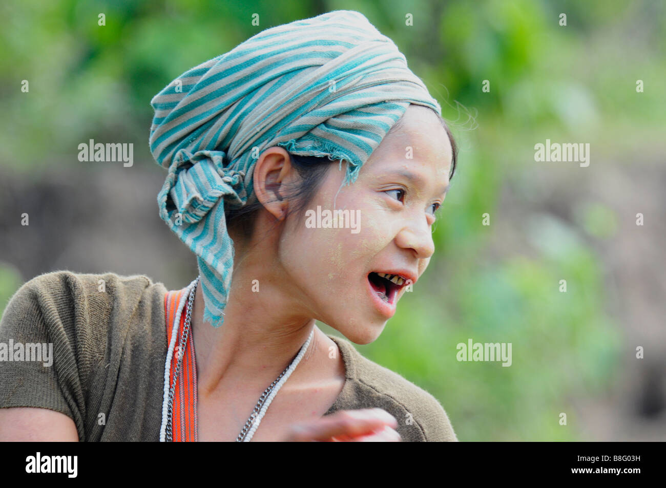 Karen hilltribe lady with black teeth and tanaka on her smiling face ...