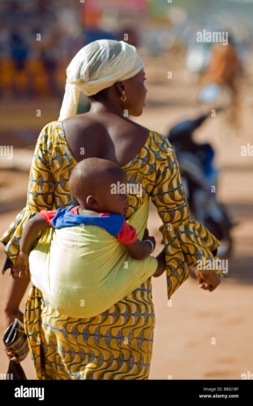 Woman walking carrying baby on back hi-res stock photography and images ...