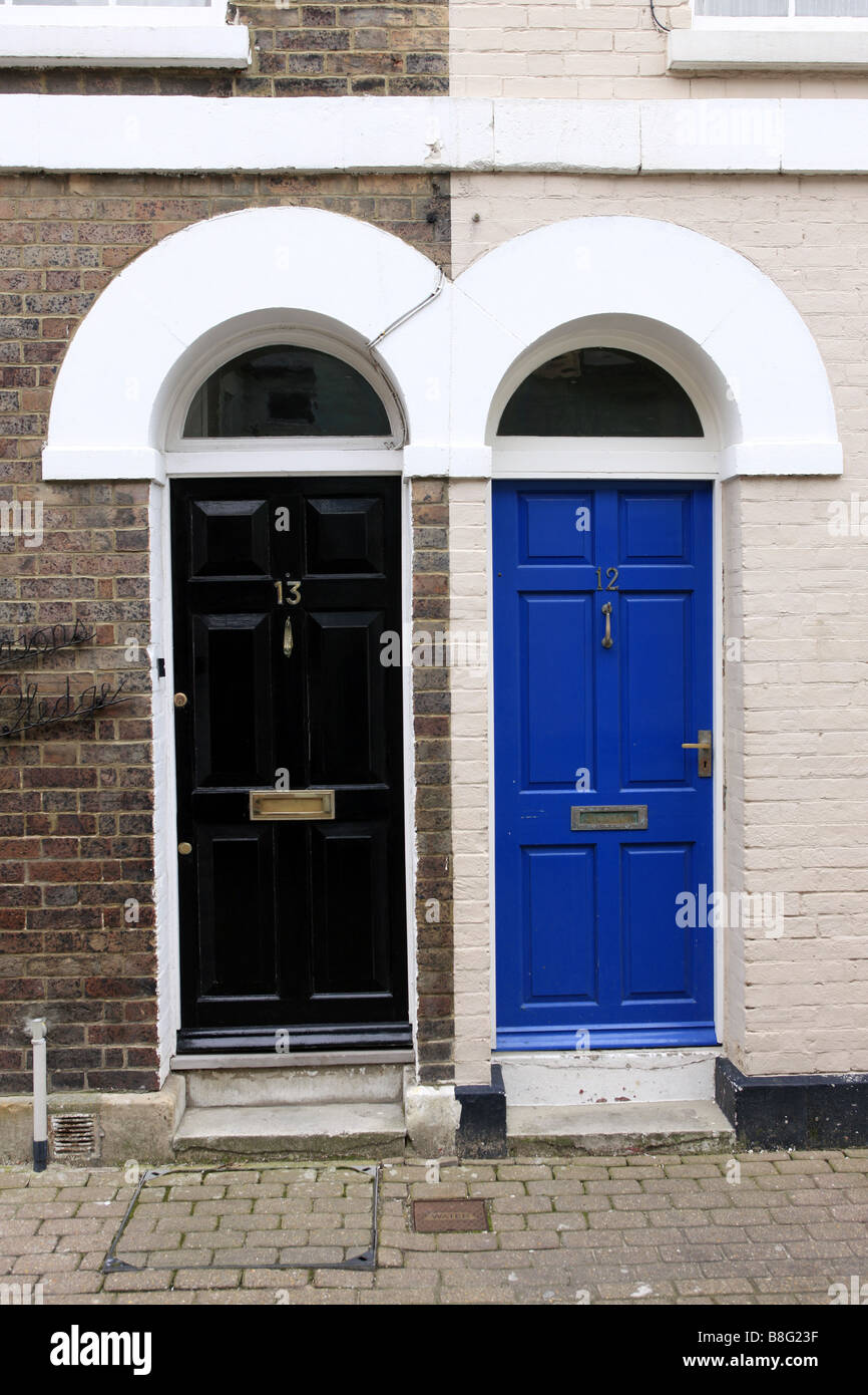 Two doors directly next to each other with a double arch Stock Photo ...