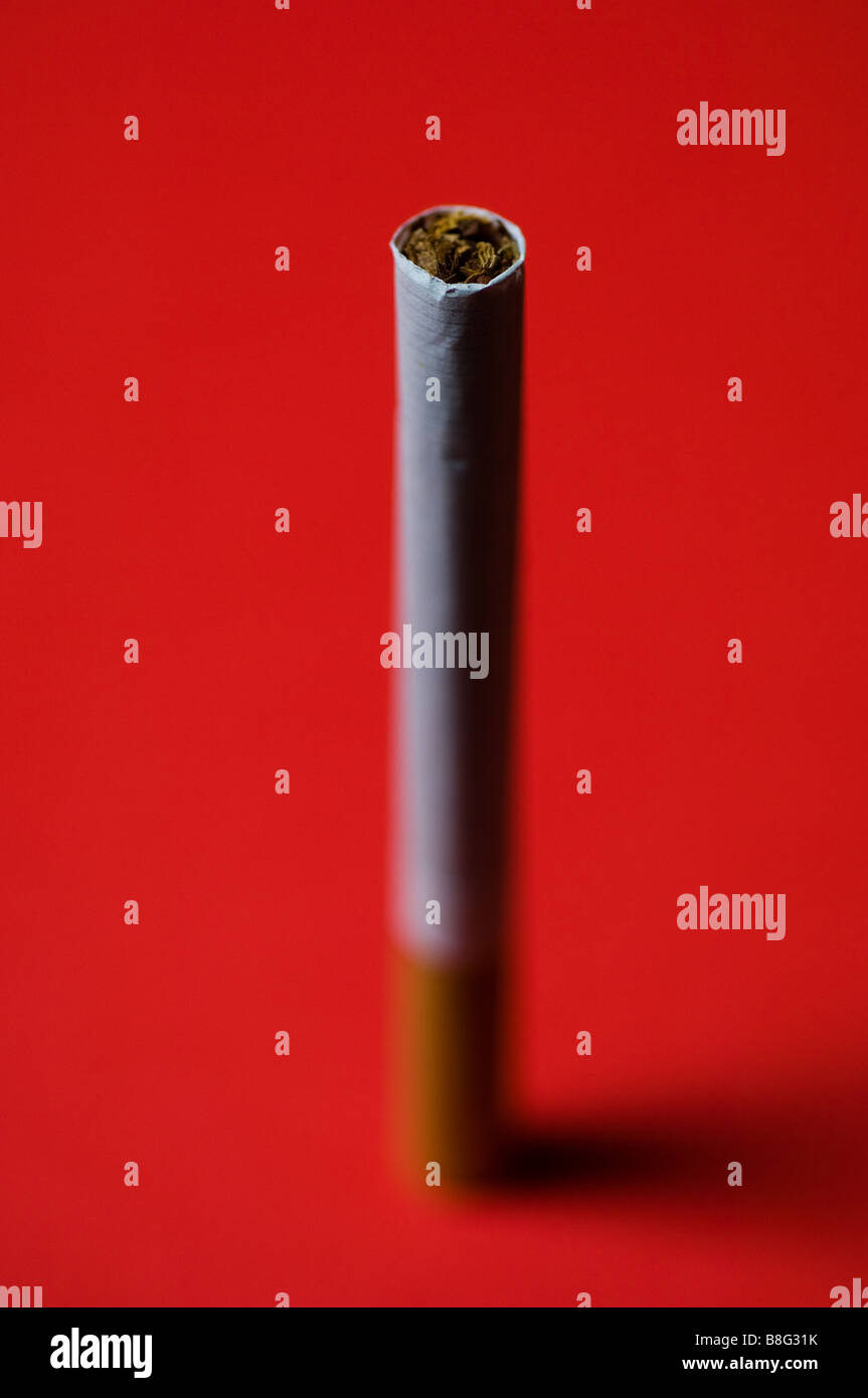 A cigarette on a red background Stock Photo - Alamy