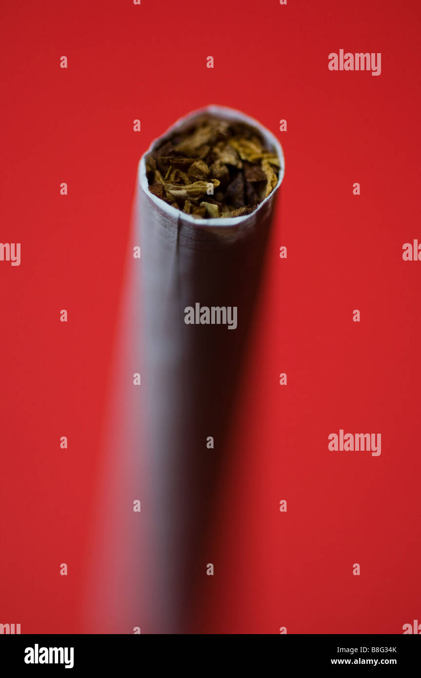 A cigarette on a red background Stock Photo - Alamy