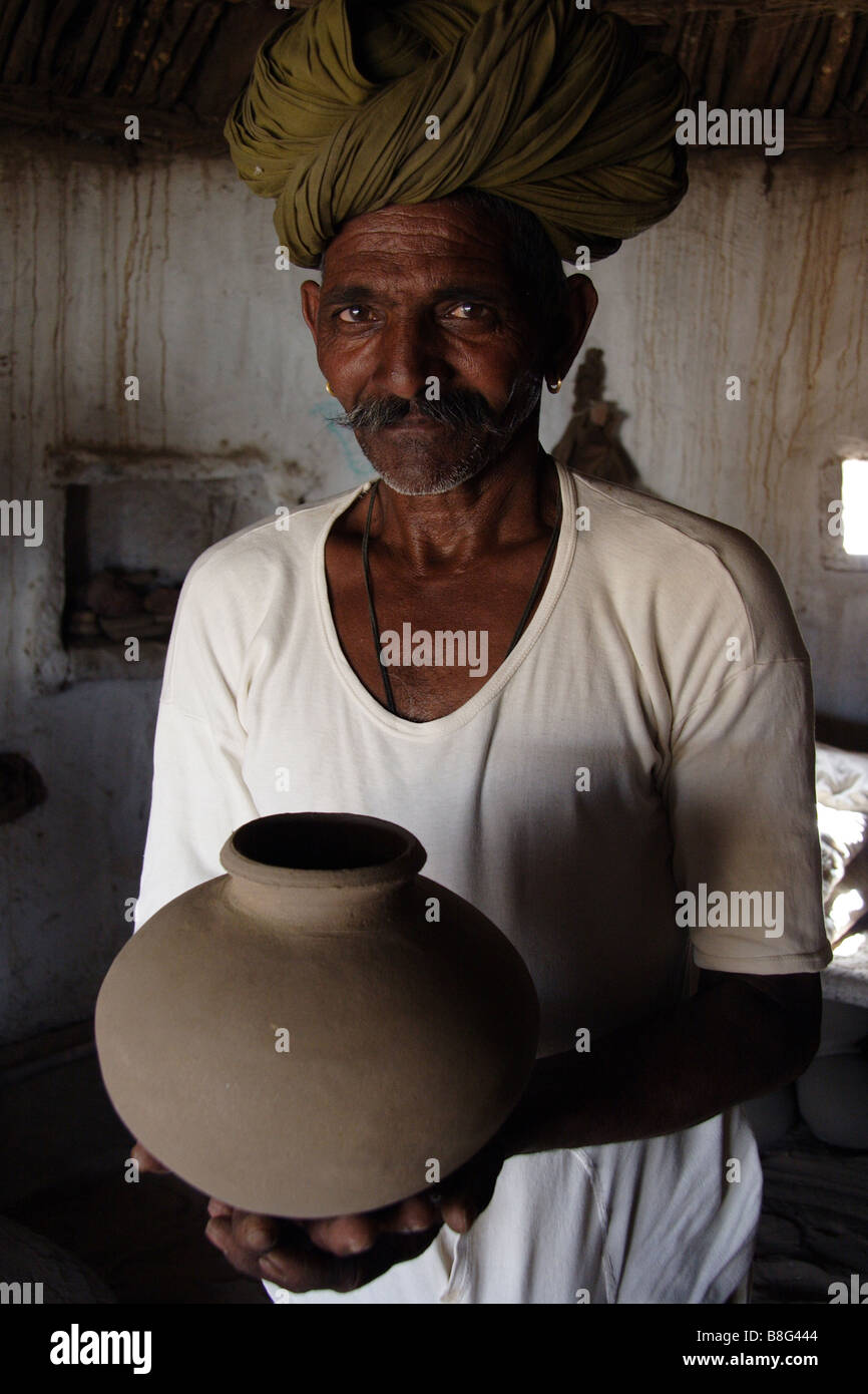 Indian man holds clay pot Stock Photo - Alamy