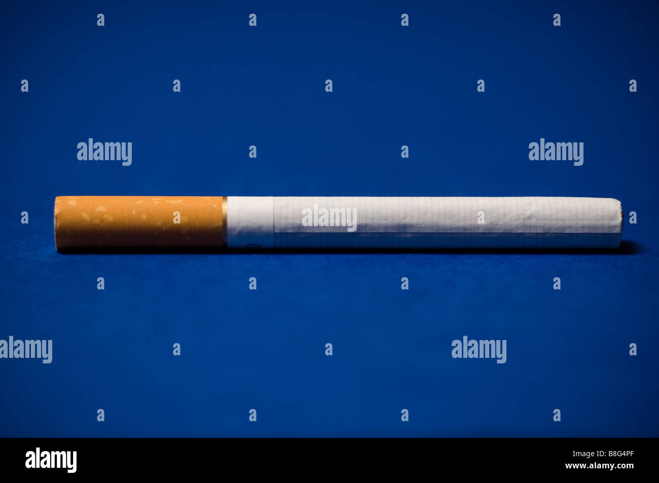 A cigarette on a blue background Stock Photo - Alamy
