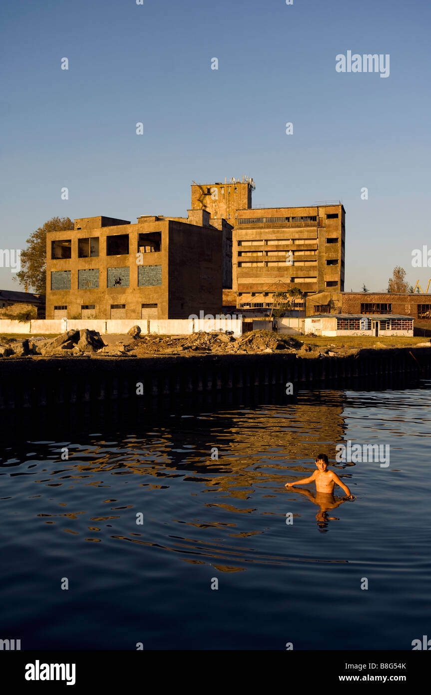 a boy in the water at the harbour, poti, georgia Stock Photo - Alamy
