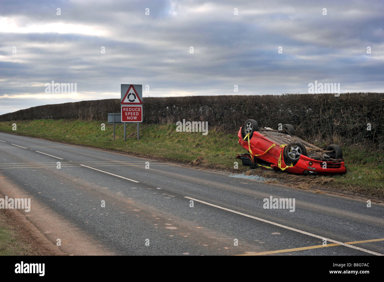 Car crash / car wreck of sports car with reduce speed sign in ...