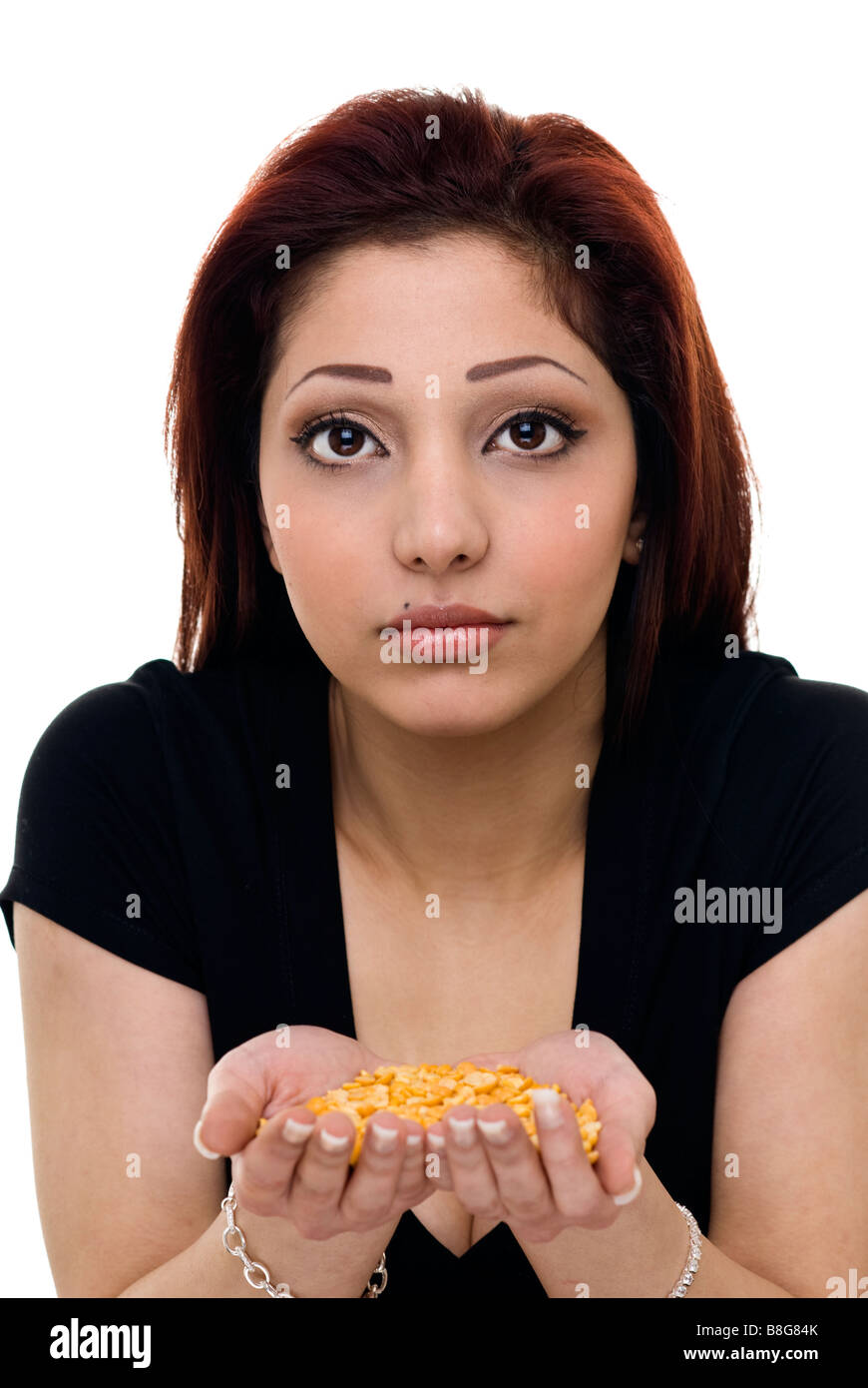 ethnic woman holding yellow split peas Stock Photo - Alamy