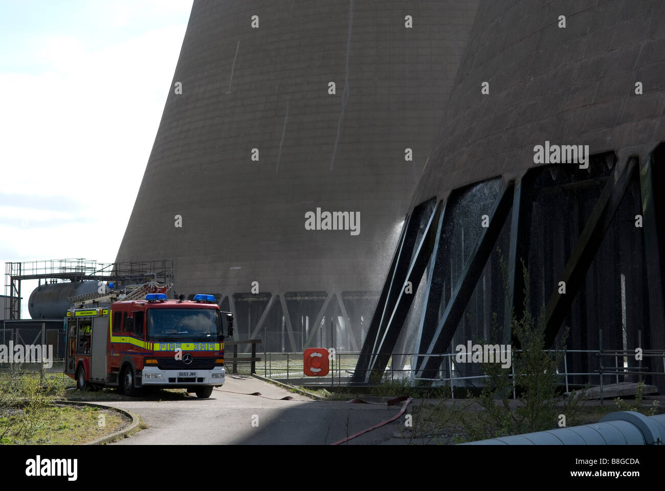 fire engine at base of cooling towers at power station Stock Photo - Alamy