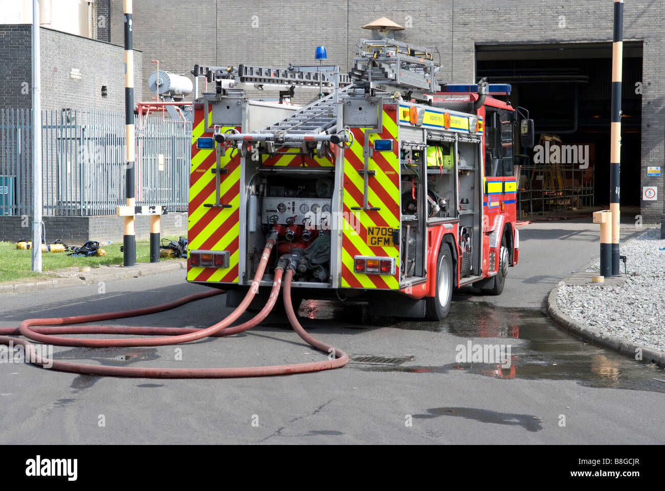 Rear of fire appliance with pump in use and main branches and feeds ...