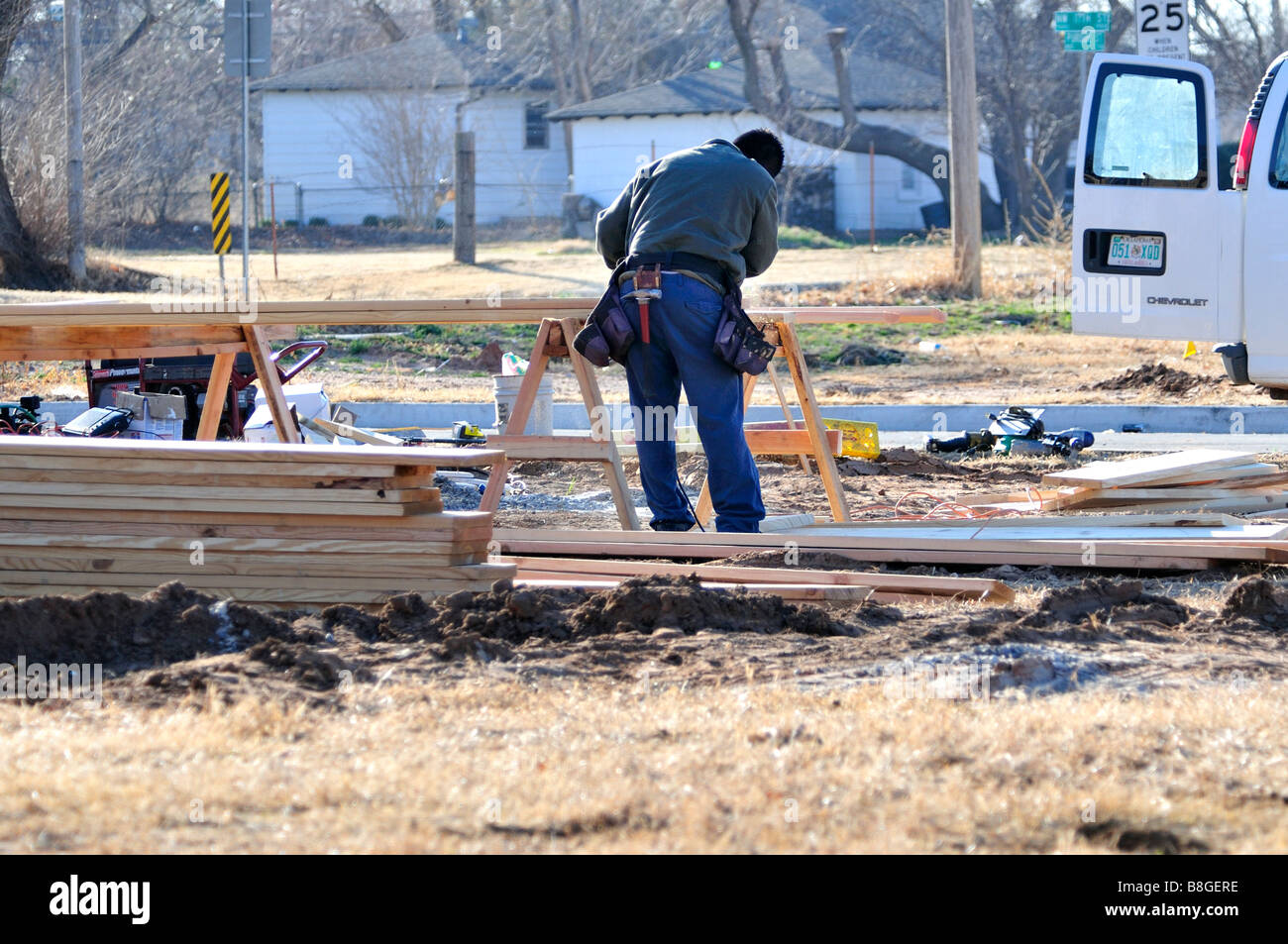 A male construction worker at a new home construction site in Oklahoma ...