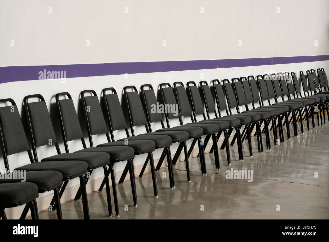 Row of chairs along wall Stock Photo - Alamy