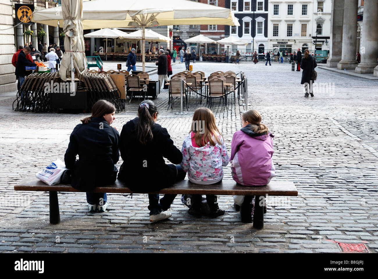Children sitting on a bench Stock Photo - Alamy