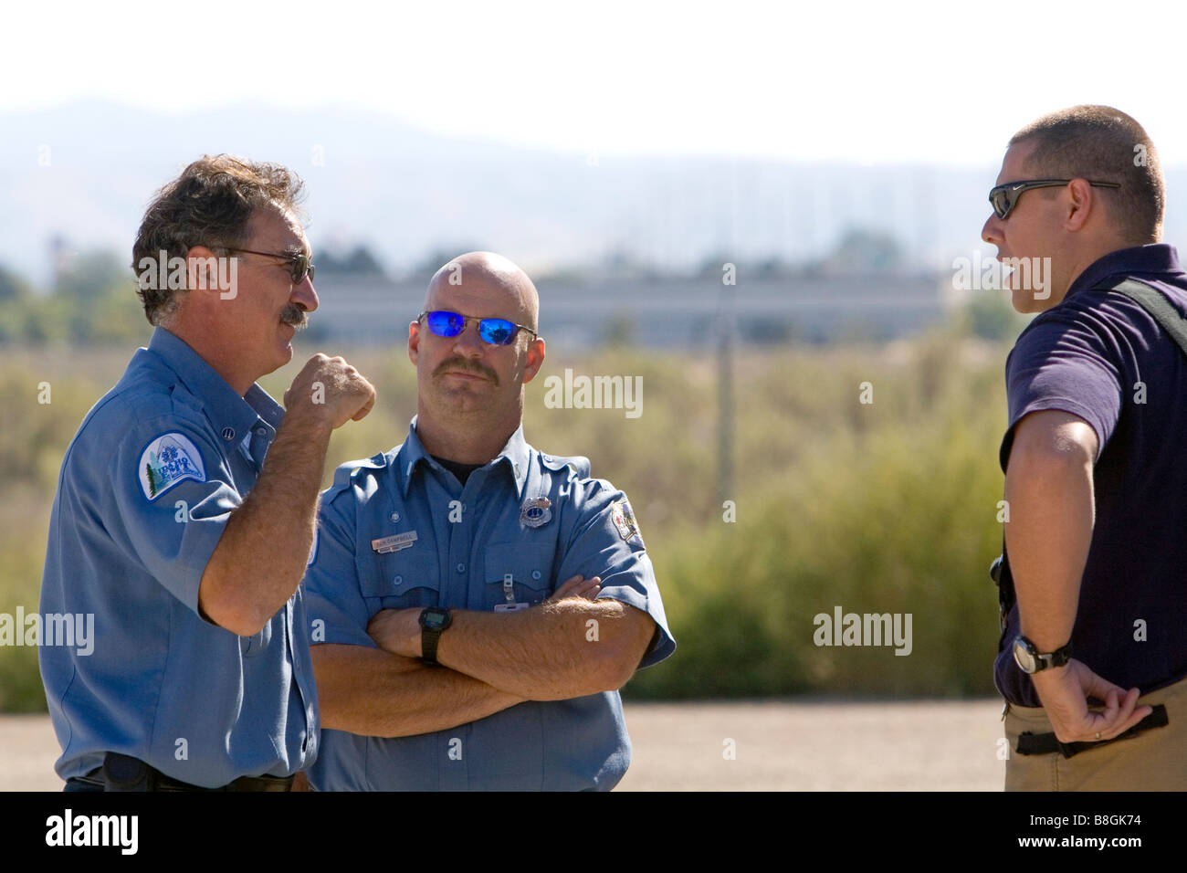 Firefighters taking direction from a training officer at an airport ...