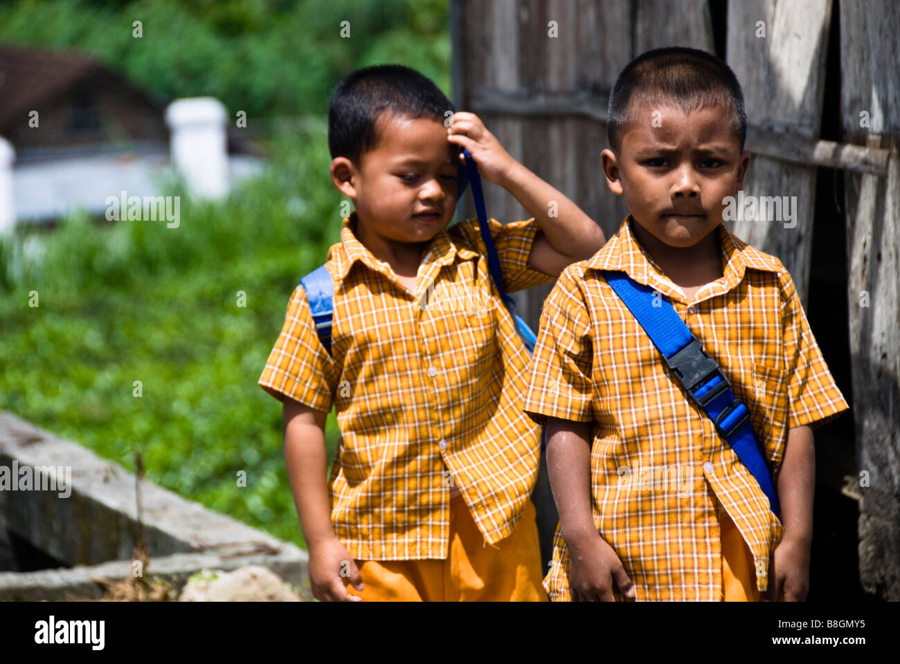 Children in the street wearing school uniform in a village near Solo ...