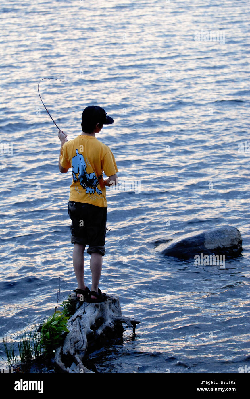 Fisherman with fishing rod Stock Photo - Alamy