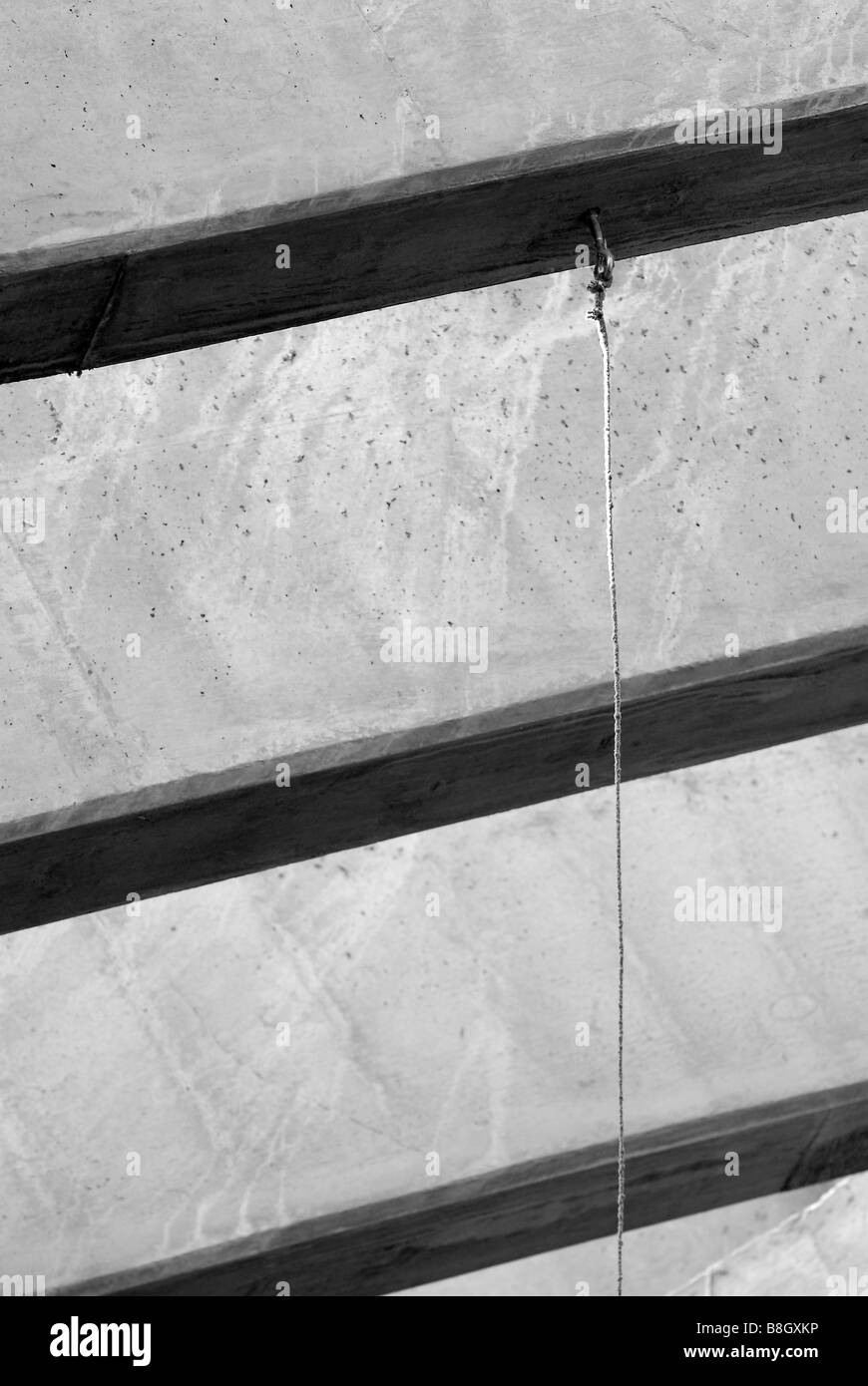 Anchor pin embedded into concrete column with suspended rope Stock ...